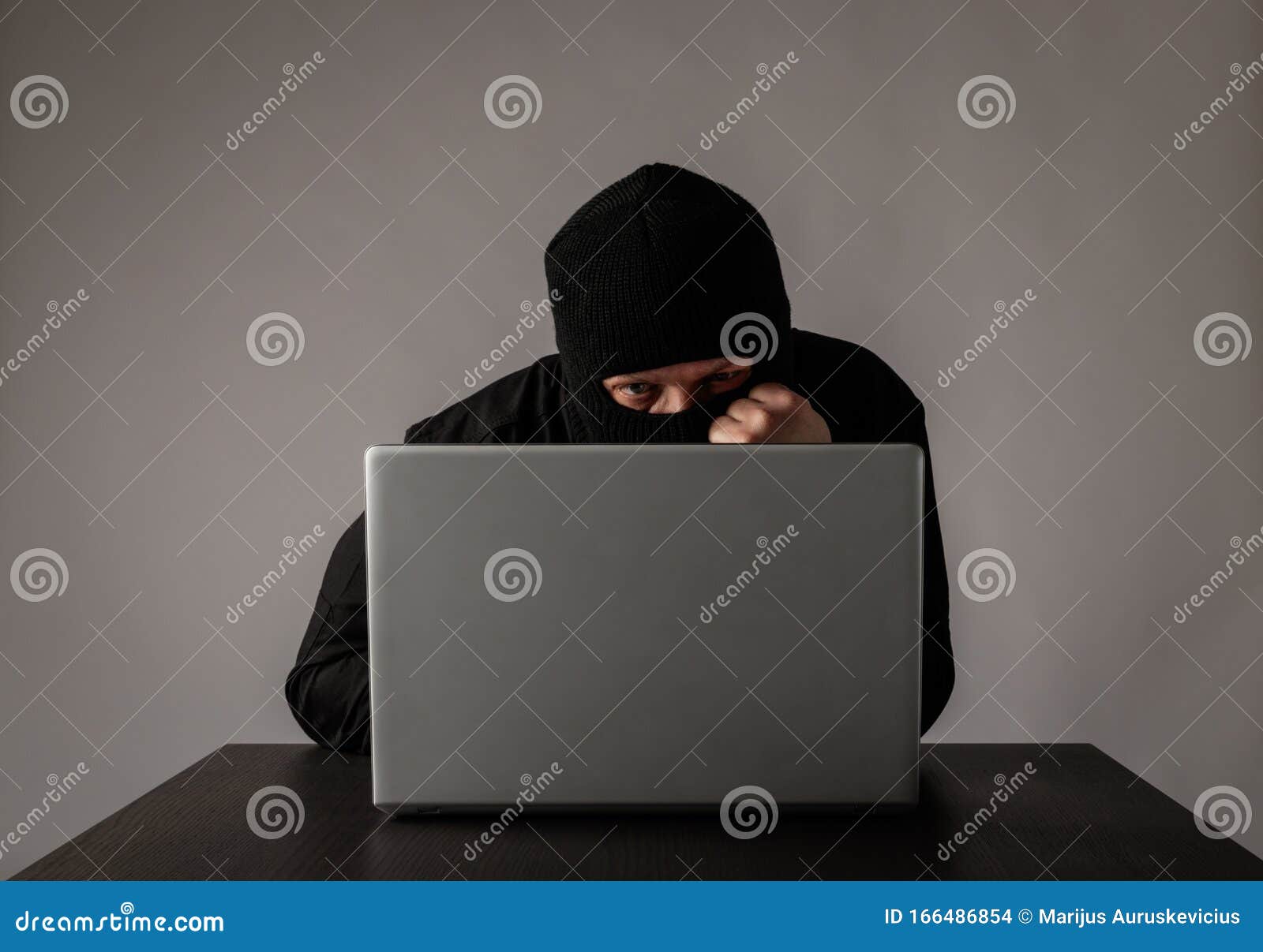 Hacker in Mask Using a Laptop Stock Photo - Image of aggressor ...