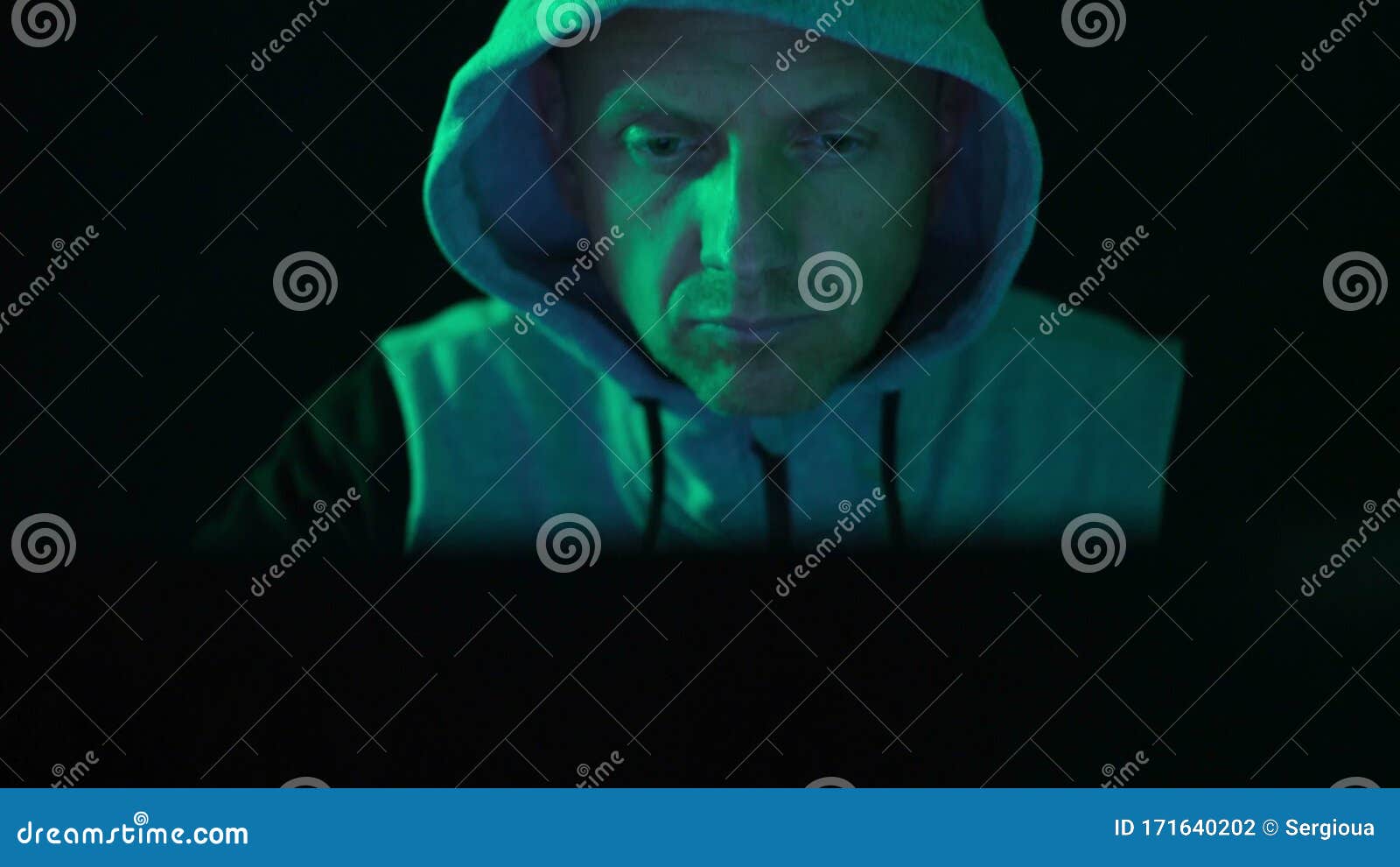 A Hacker Programmer, at Night at a Laptop Computer, Creates Virus ...