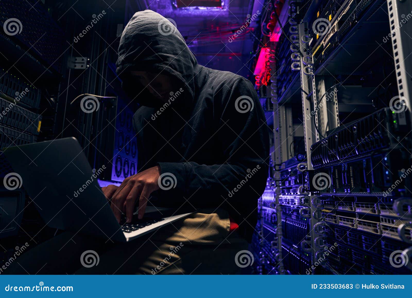 Hacker Seated in Server Room Launching Cyberattack on Laptop Stock ...