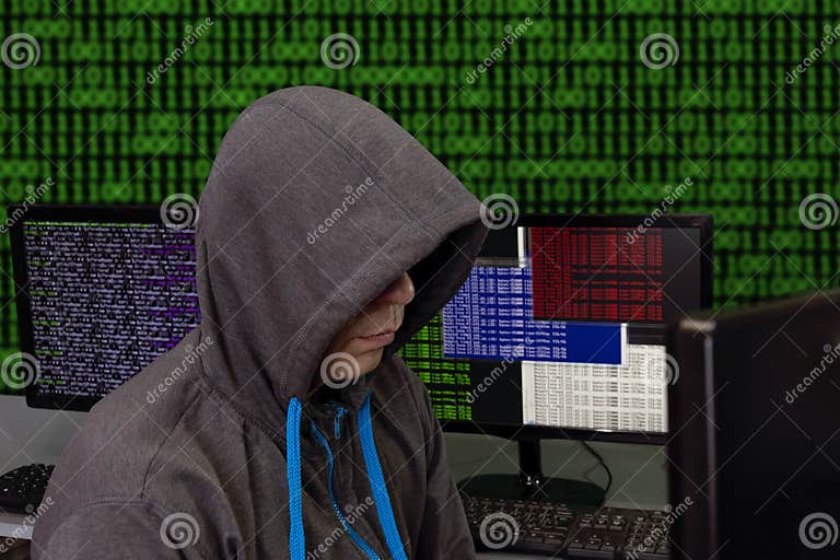A Hacker Sits Behind Computer Monitors on an Abstract Background ...