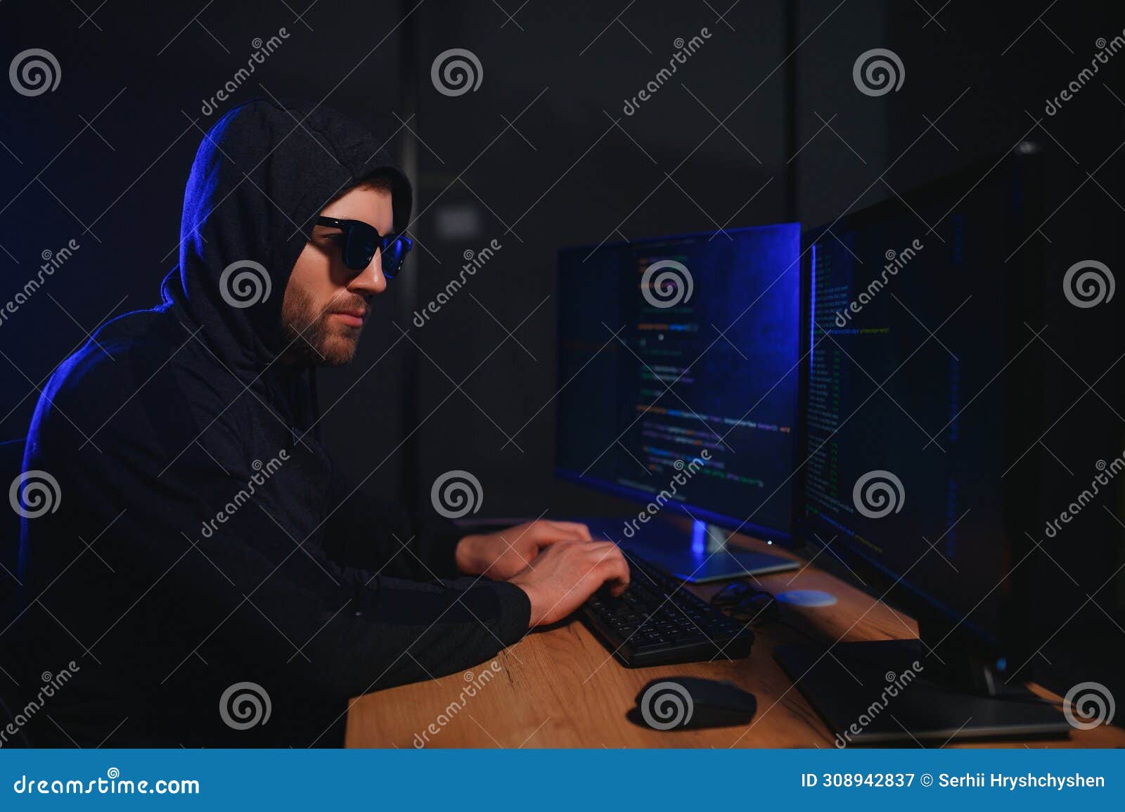 Hacker Sitting at Desk in Dark Atmosphere. a Computer Programmer or ...