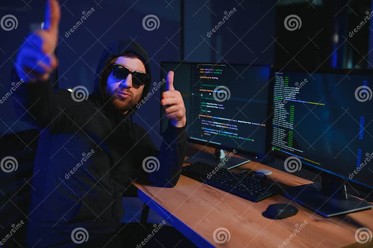 Hacker Sitting At Desk In Dark Atmosphere A Computer Programmer Or Hacker Anonymous Computer
