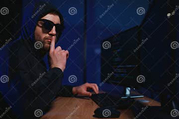 Hacker Sitting at Desk in Dark Atmosphere. a Computer Programmer or ...