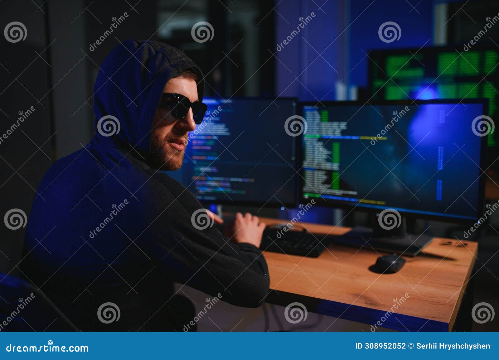 Hacker Sitting at Desk in Dark Atmosphere. a Computer Programmer or ...
