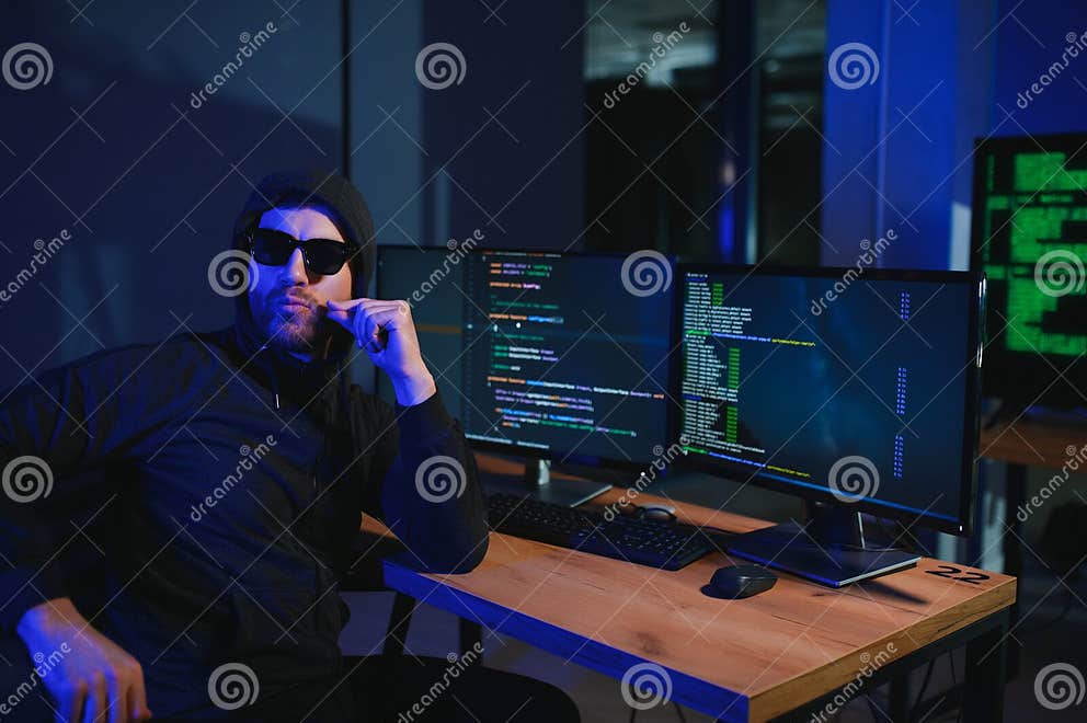 Hacker Sitting At Desk In Dark Atmosphere A Computer Programmer Or Hacker Anonymous Computer