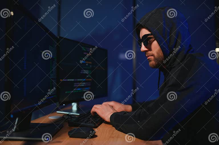Hacker Sitting At Desk In Dark Atmosphere A Computer Programmer Or Hacker Anonymous Computer
