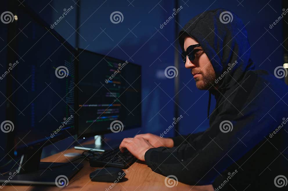 Hacker Sitting at Desk in Dark Atmosphere. a Computer Programmer or Hacker. Anonymous Computer ...