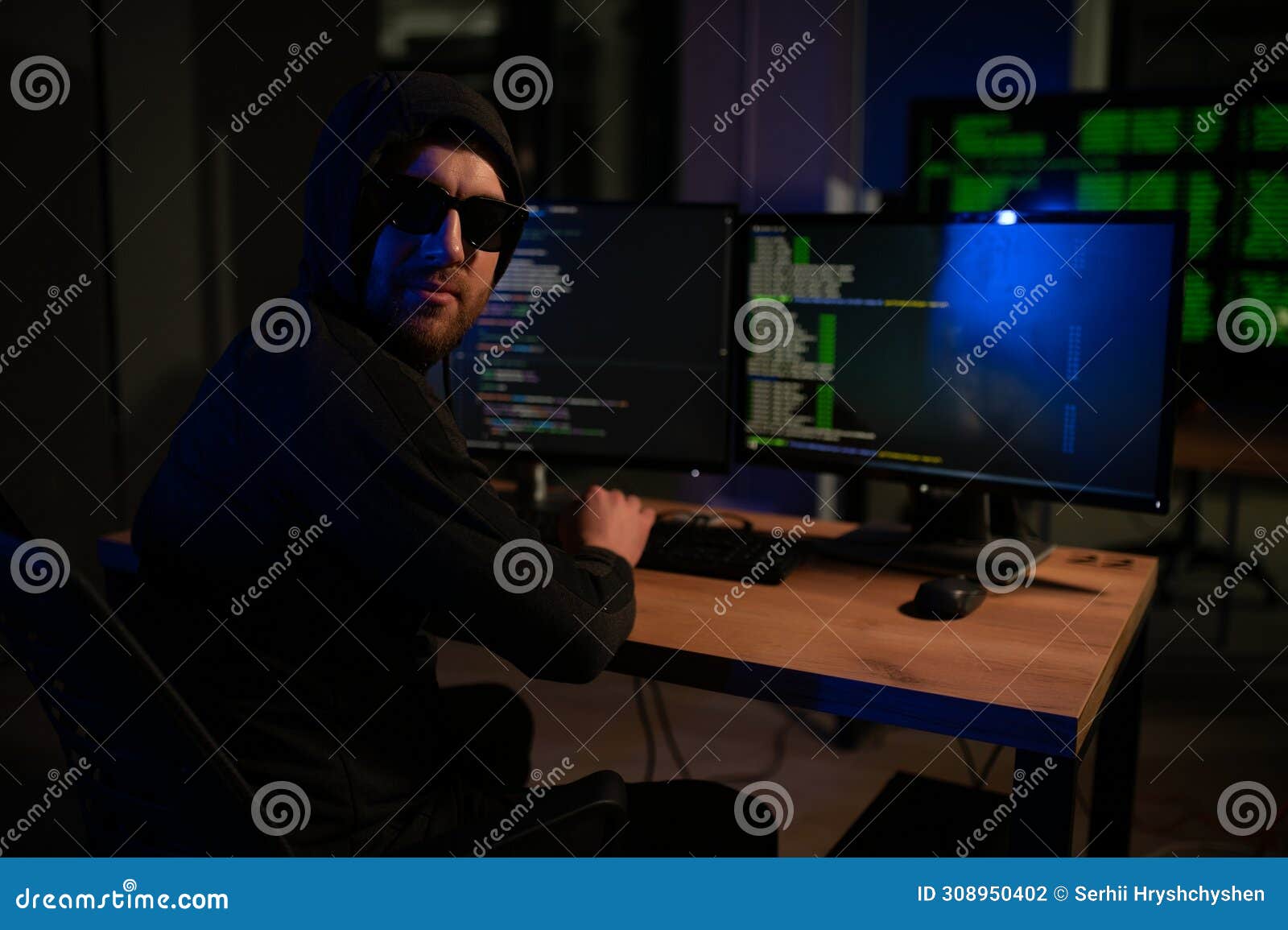 Hacker Sitting at Desk in Dark Atmosphere. a Computer Programmer or ...