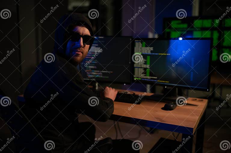 Hacker Sitting at Desk in Dark Atmosphere. a Computer Programmer or ...