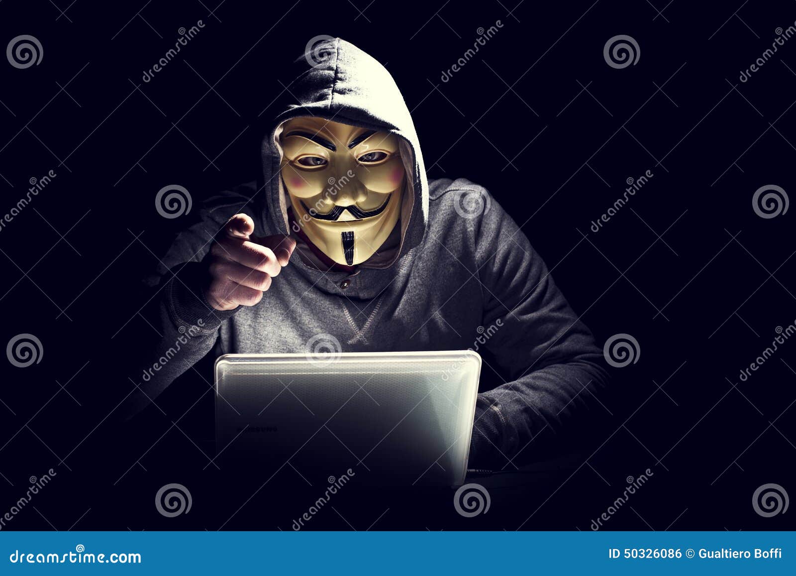 Portrait Of Hacker Man With Mask Looking Back While Typing Laptop On ...