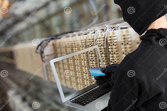 Hacker Using a Laptop in a Data Center Stock Image - Image of disguise ...
