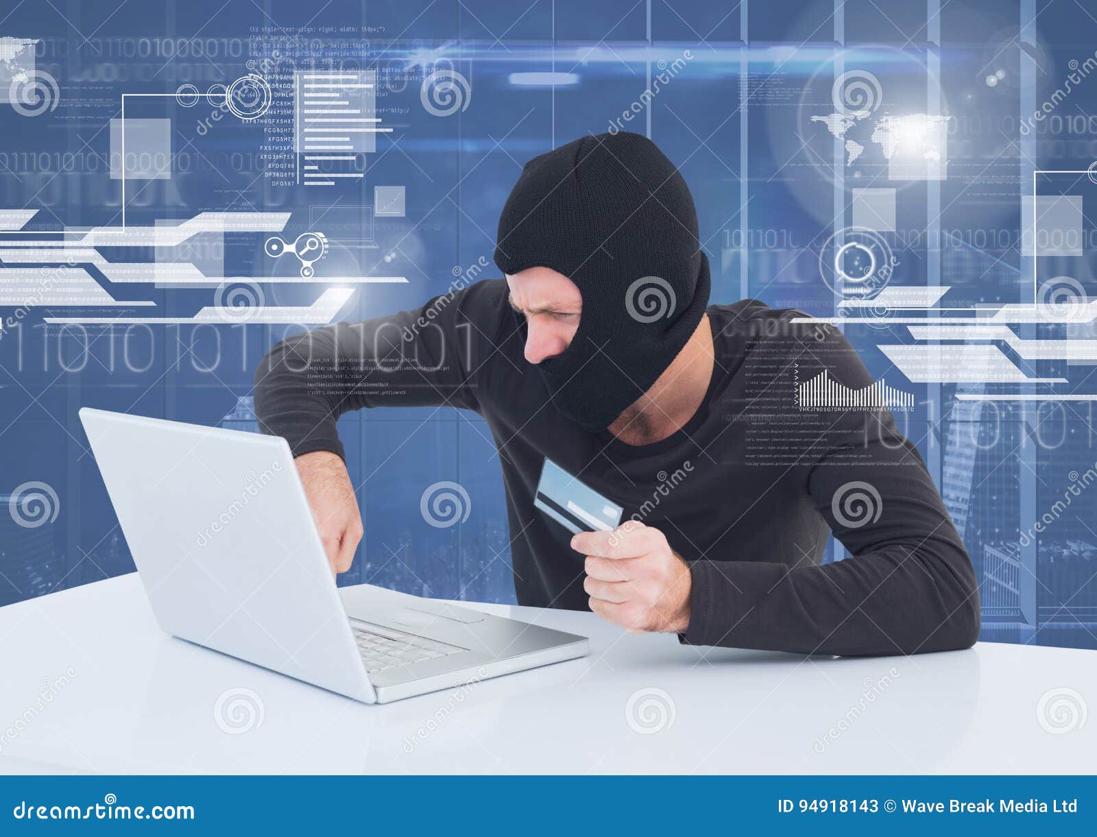Hacker Using a Laptop and Holding a Credit Card in Front of Digital ...