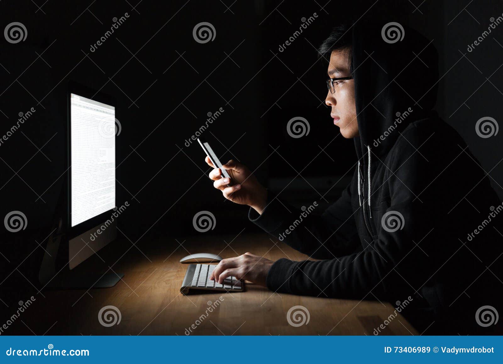 Hacker Using Laptop and Mobile Phone in Dark Room Stock Image - Image ...