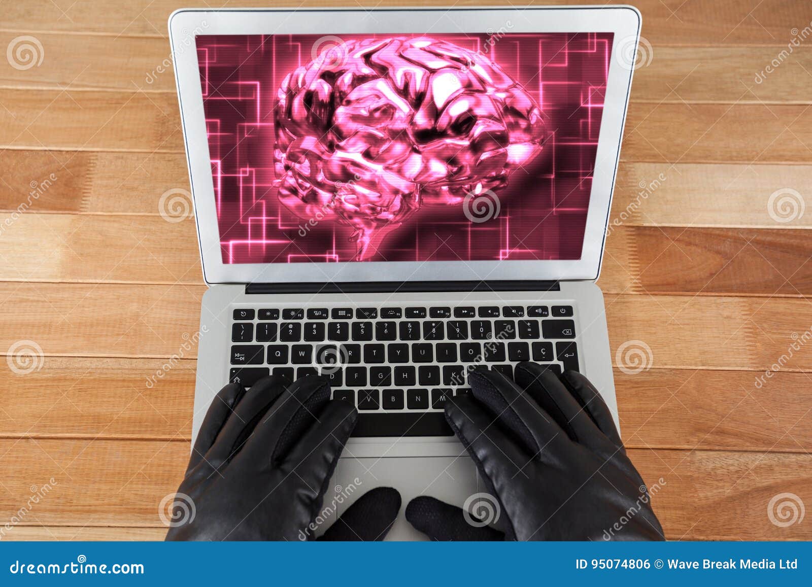Hacker Wearing Gloves Using a Laptop with a Pink Brain on Desktop ...