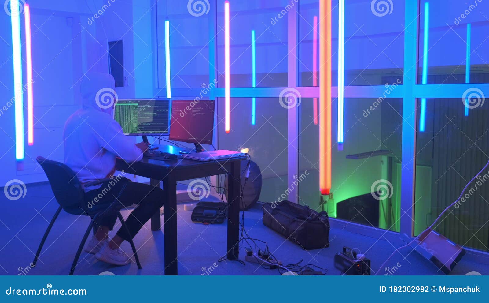 Hacker Working Place: Hacker Working in a Room with Colored Neon Lights ...
