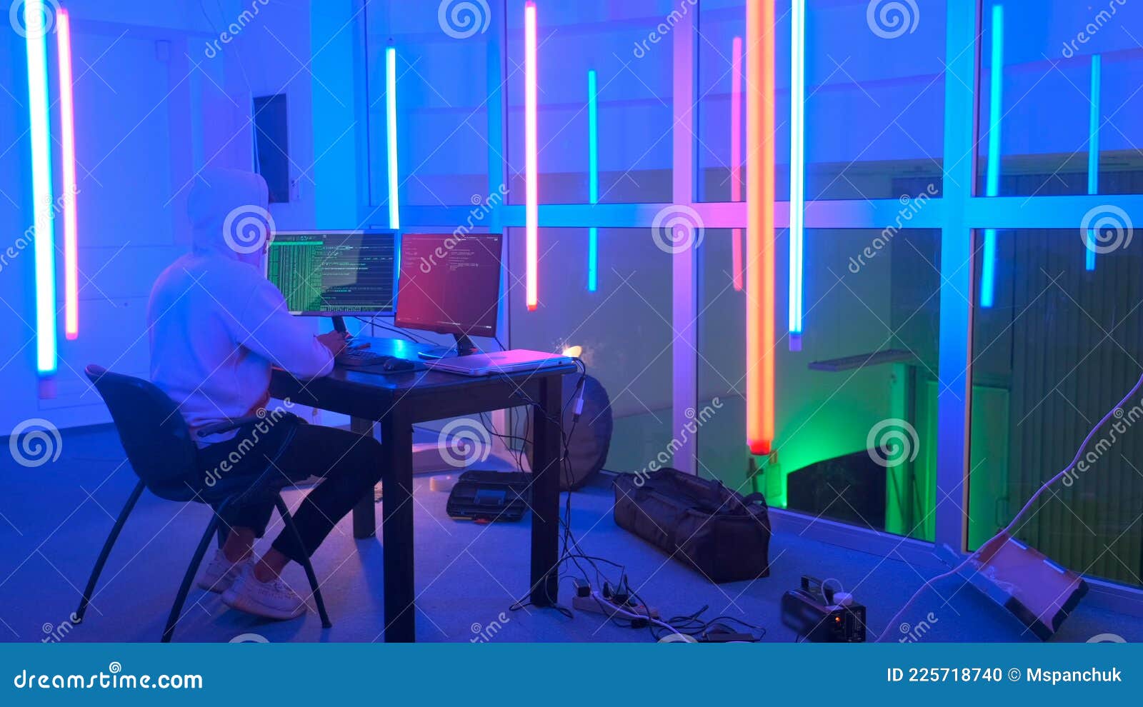 Hacker Working Place: Hacker Working in a Room with Colored Neon Lights ...