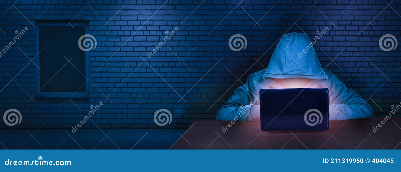 The Hacker Works Behind a Laptop Screen in a Room with a Brick Wall ...