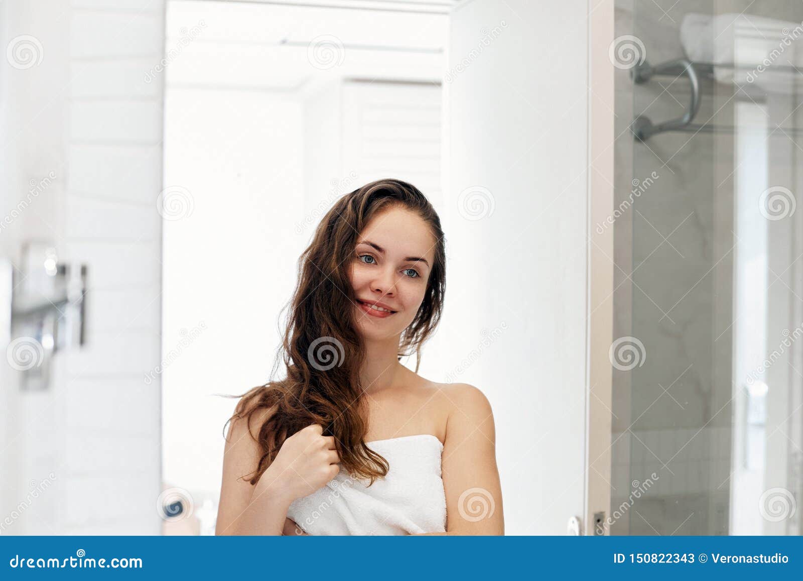Hair And Body Care Woman Touching Hair And Smiling While Looking In