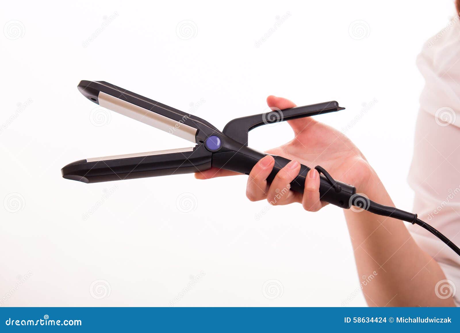 Hair straightener in hand stock photo. Image of straighten - 58634424