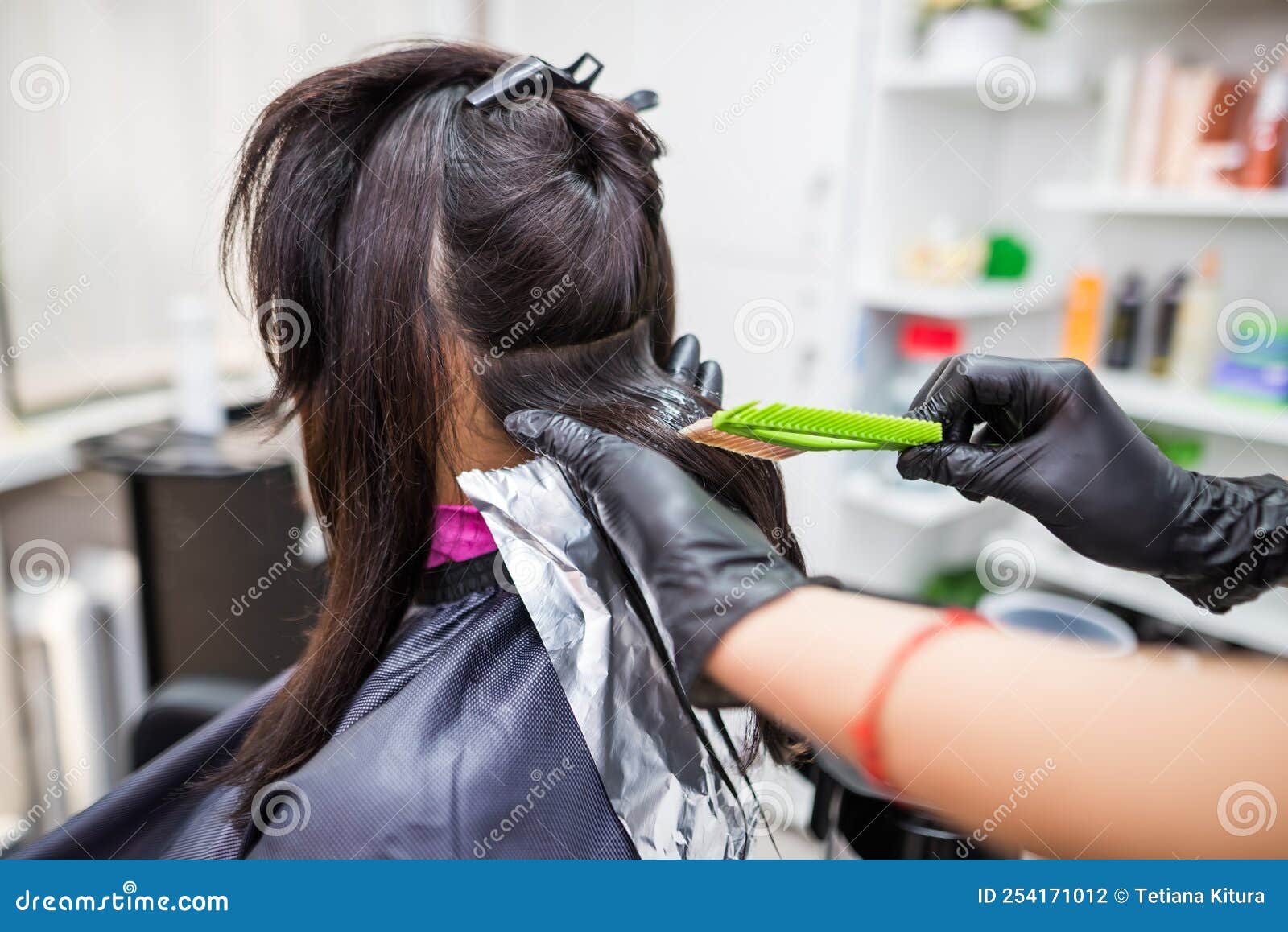 The Hairdresser Applies Professional Liquid Keratin To The Client`s