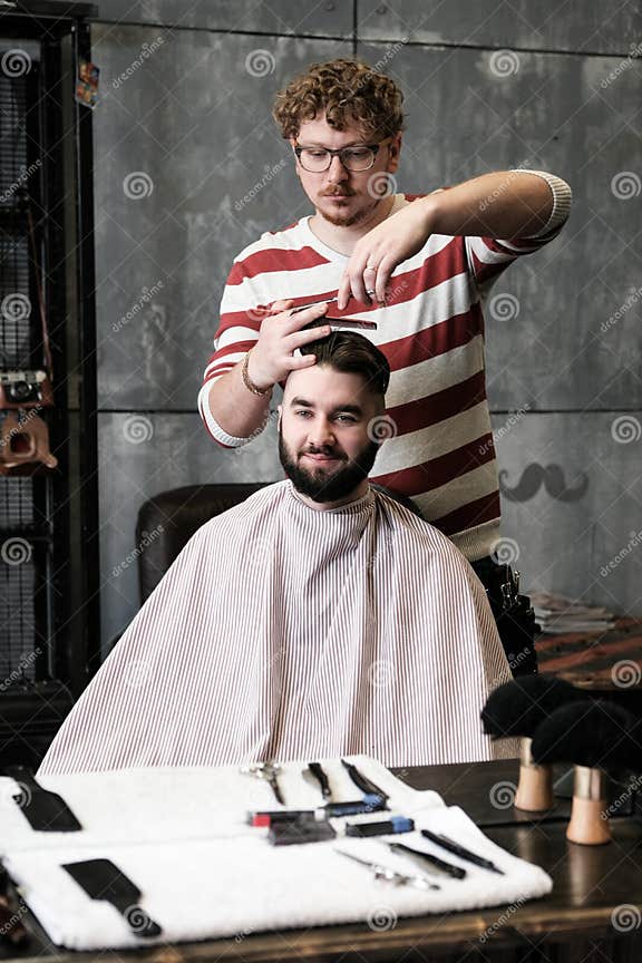 Hairdresser Man Shaves a Client with a Beard in a Barbershop Stock ... Hairdresser Man Shaves a Client with a Beard in a Barbershop Stock ...