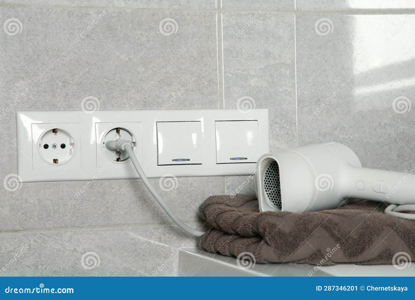 Hairdryer Plugged into Power Socket on Light Grey Wall Stock Image ...