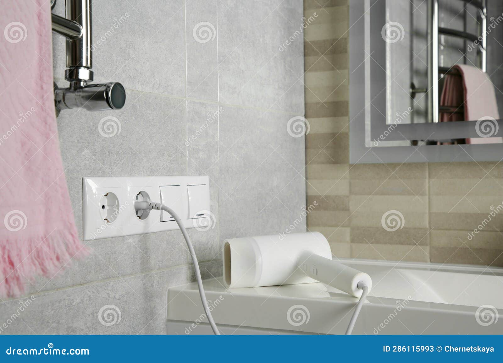 Hairdryer Plugged into Power Socket on Light Grey Wall in Bathroom ...