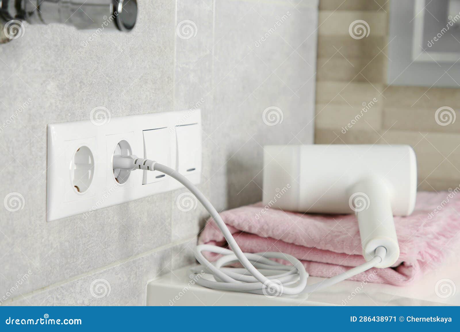 Hairdryer Plugged into Power Socket on Light Grey Wall, Space for Text ...