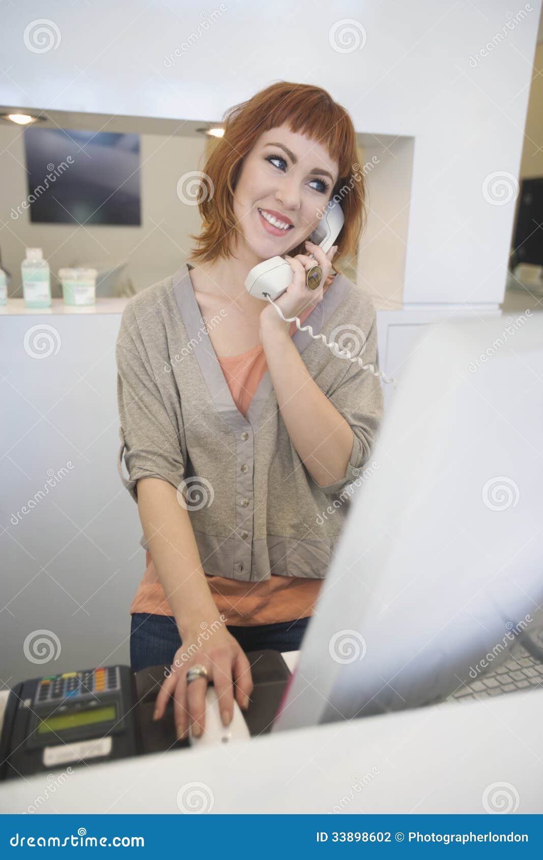 Hairstylist Answering Telephone at Reception Desk Stock Photo - Image ...