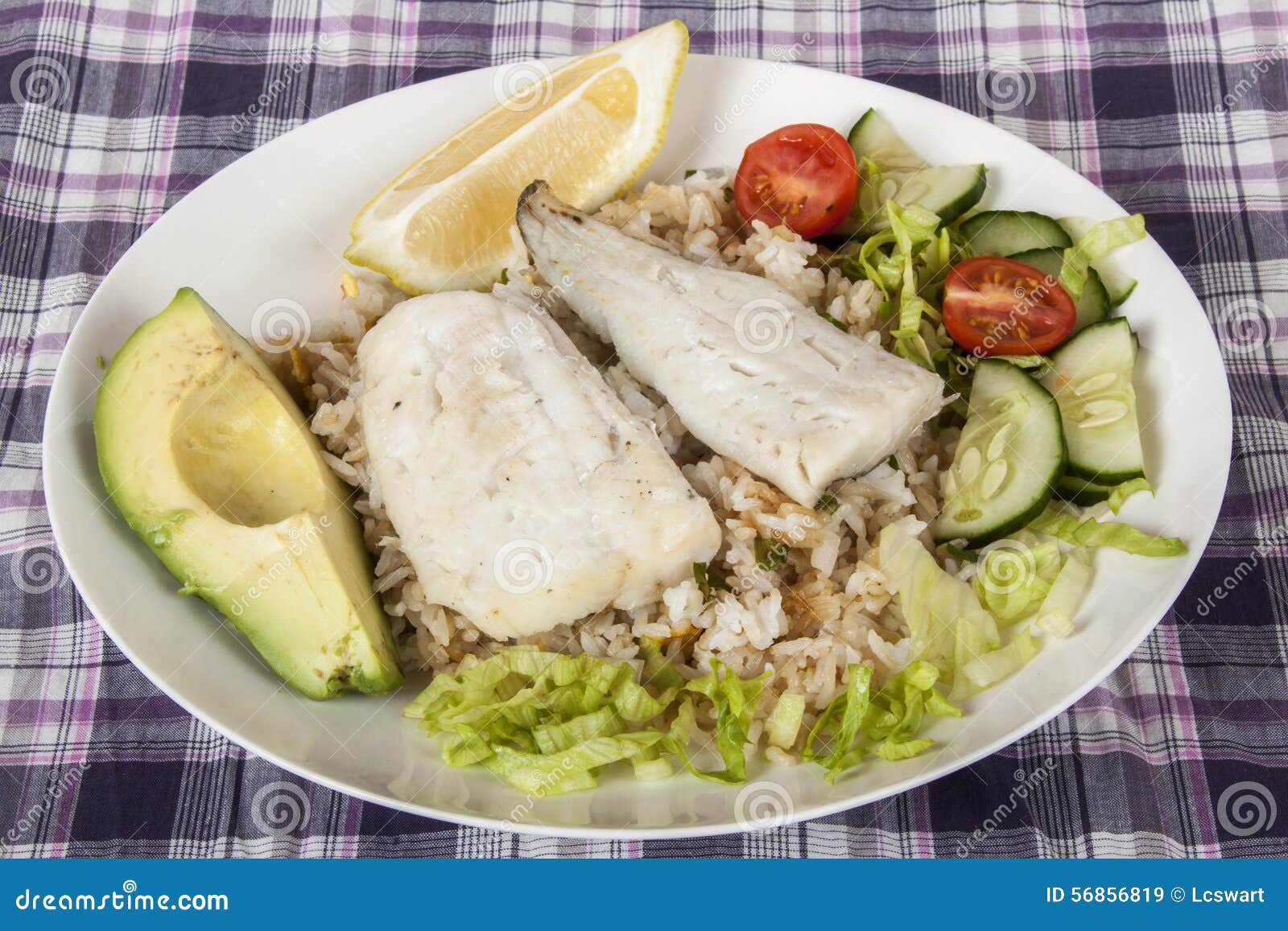 Hake on Fried Jasmine Rice with Lemon, Avocado and Salad Stock Image ...