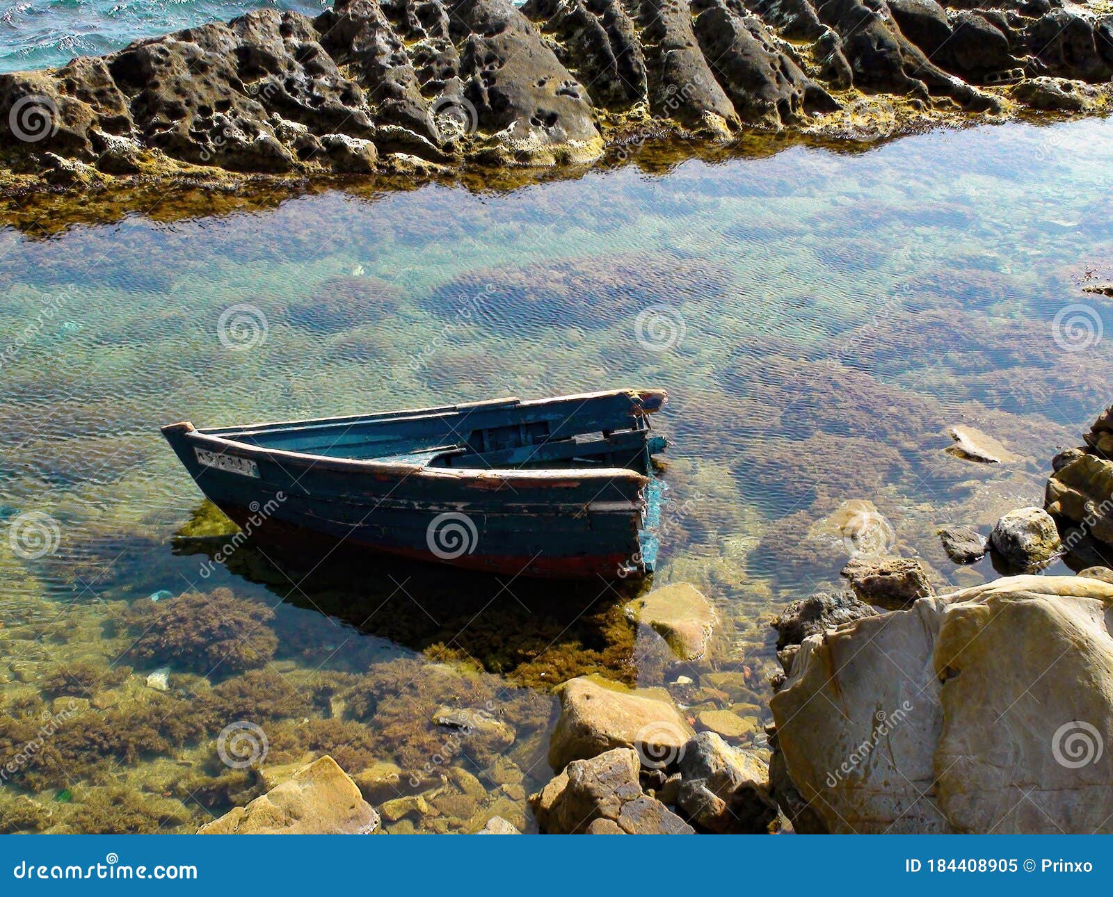 Half boat by the sea stock image. Image of water, rocks - 184408905