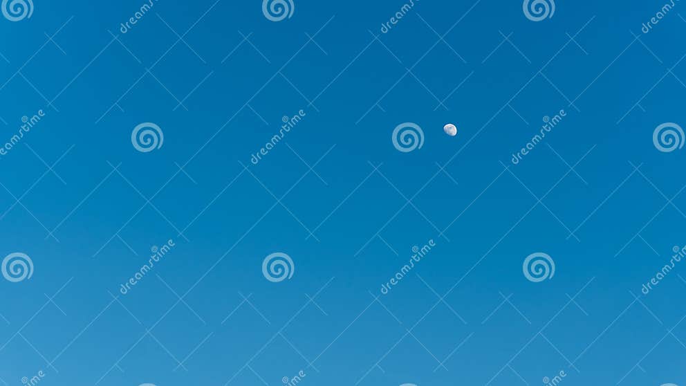 Half Bright Moon in the Middle of the Blue Sky Background Stock Photo ...