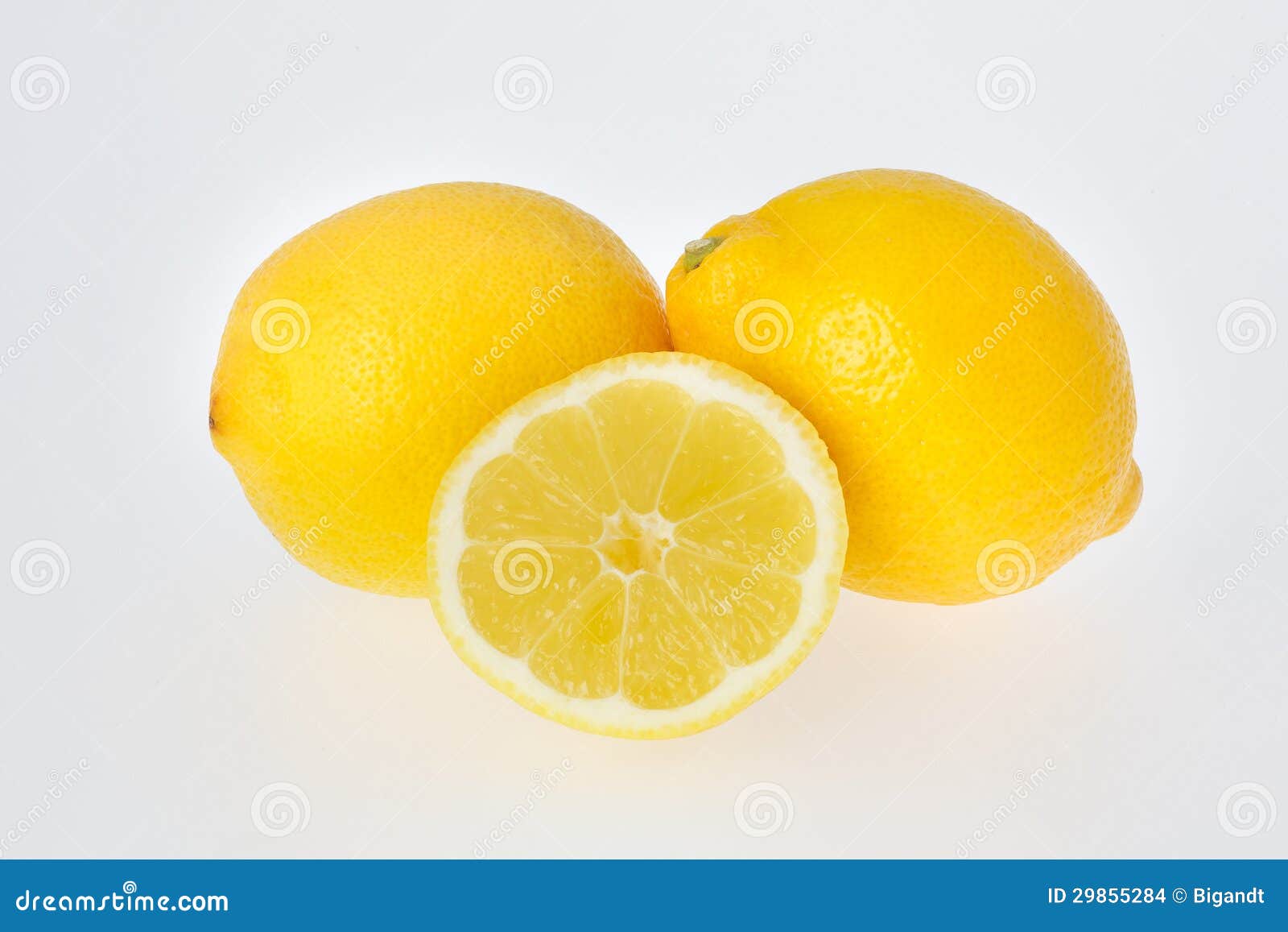 A Cut Lemon in Front of Two Lemons Stock Photo - Image of vegetables ...