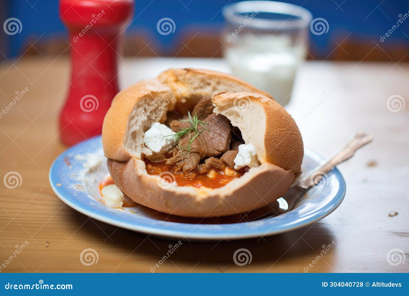 Half-eaten Goulash in Bread Bowl Showing Inside Texture on Table Stock ...
