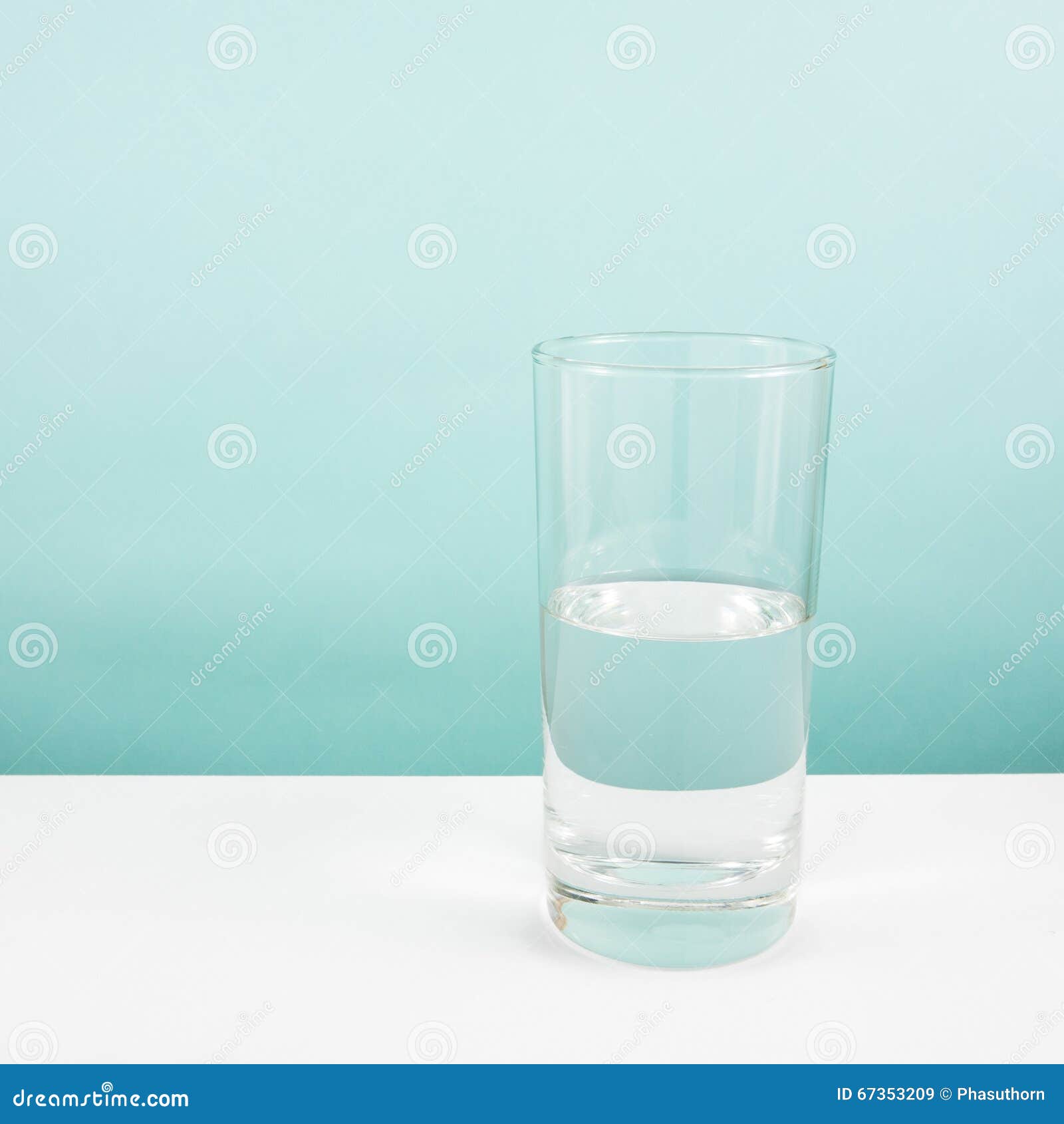 Half Empty or Half Full Glass of Water on White Table. (for Positive ...
