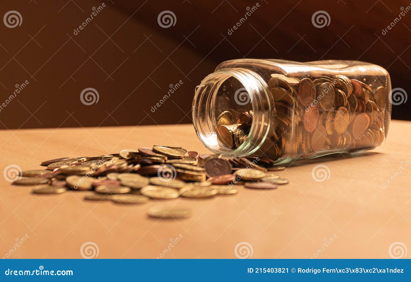 Half Empty Money Jar with Coins Over the Table. Save Money Concept ...