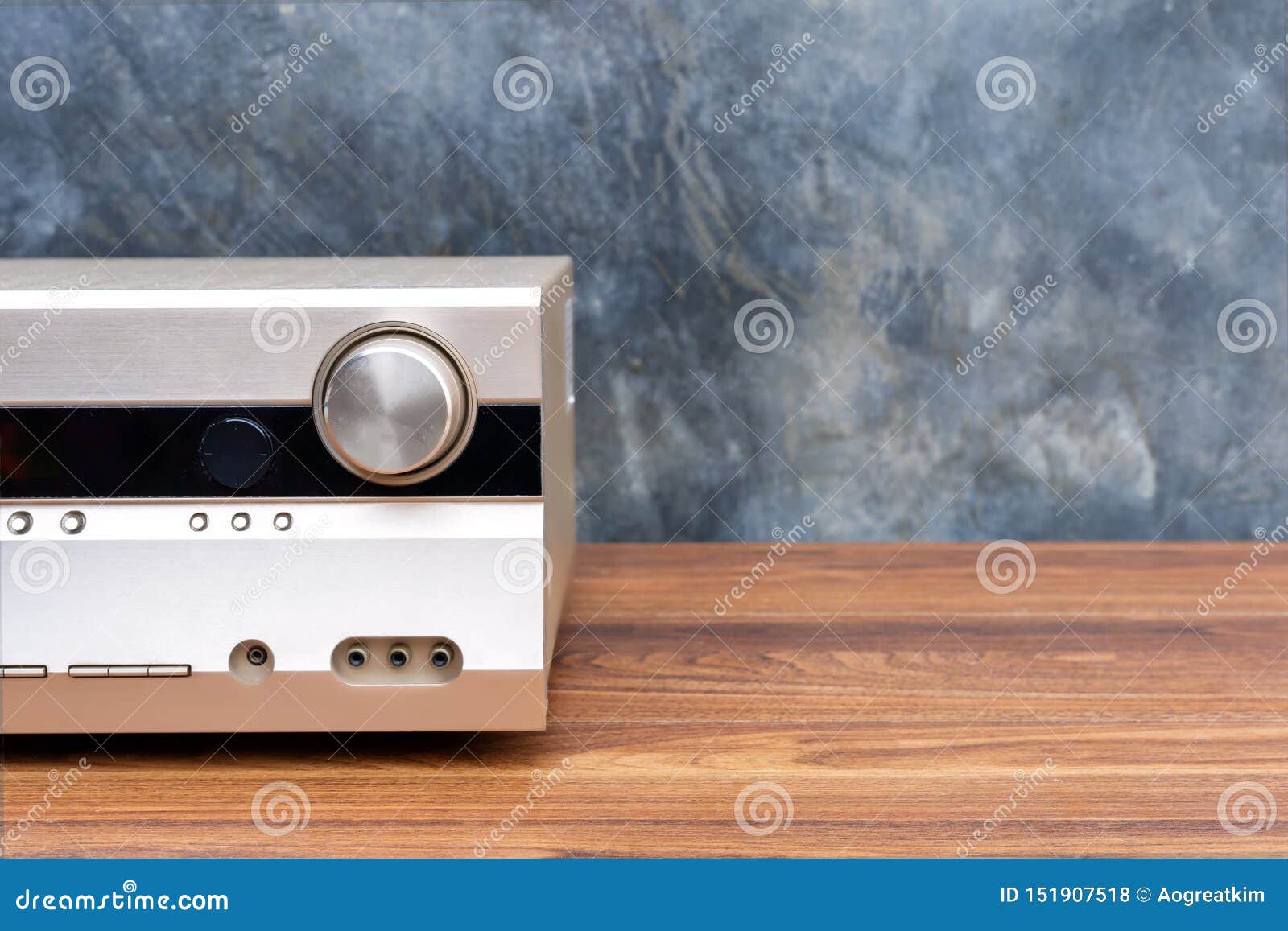 Half Front Side AV Receiver with Volume and AUX Plugin on Wood Table ...