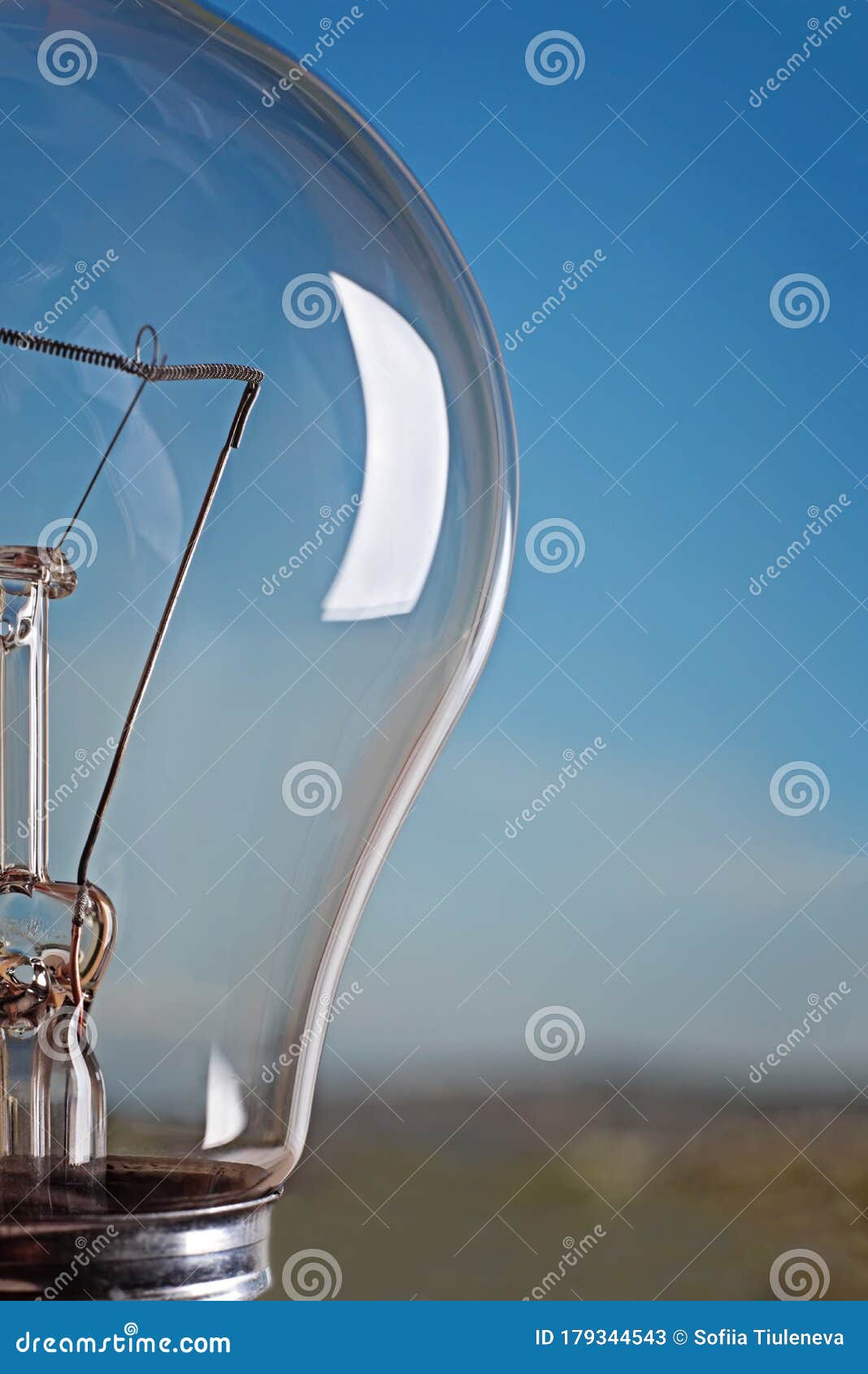 Half Light Bulb on a Background of Blue Sky and Mountains. Stock Image ...