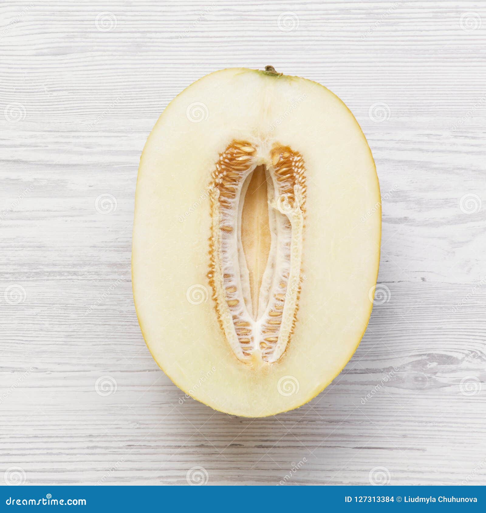 Half of Melon on White Wooden Table, Overhead View. Flat Lay, from ...