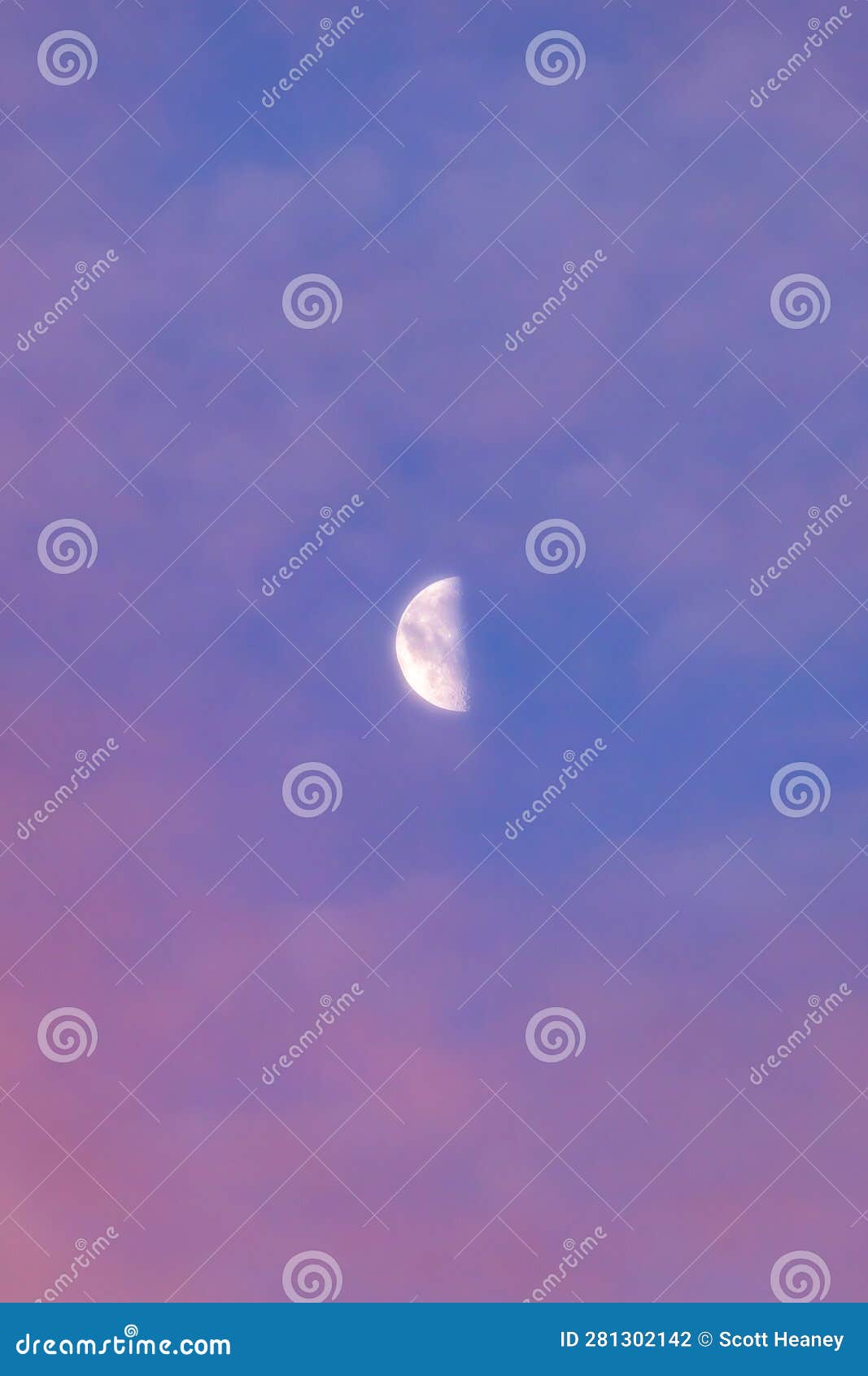 Half Moon Illuminated in the Sky Surrounded by Colorful Clouds from a ...