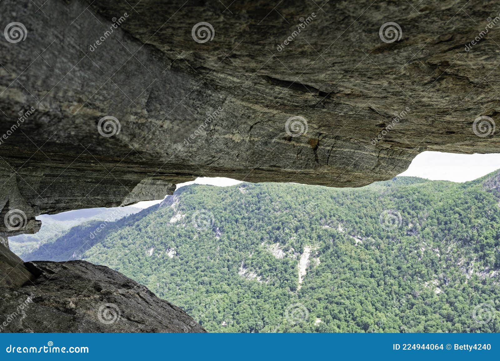 Half a Split Rock Hovers Over the Side of a Mountain. Stock Photo ...