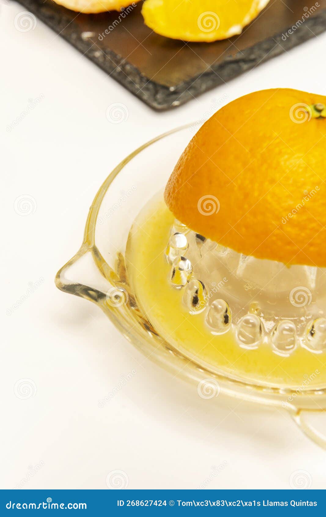 Half Orange in Glass Hand Squeezer with Juice on White Surface Stock ...