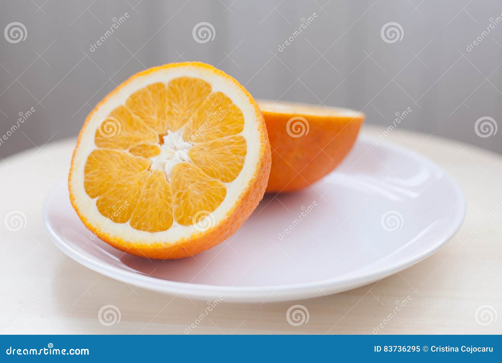 Half an orange stock image. Image of vitamin, plate, wood - 83736295