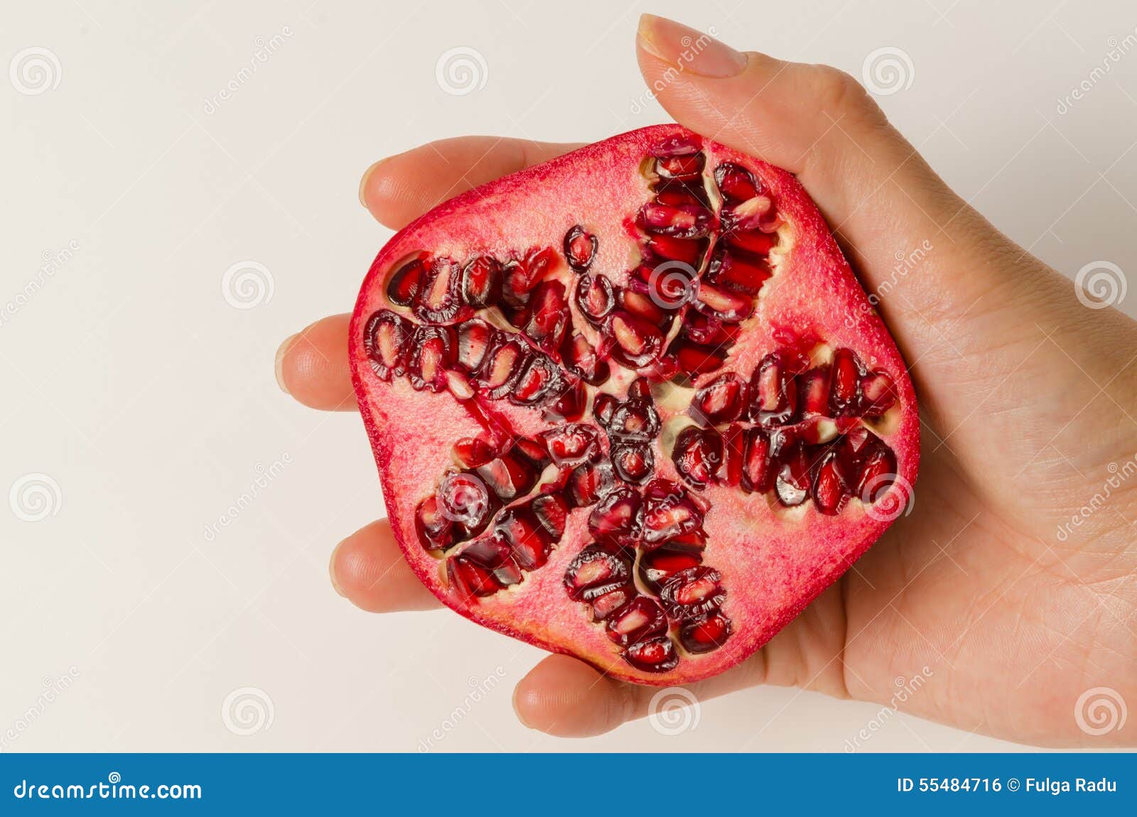 Half Pomegranate in hand stock photo. Image of background - 55484716
