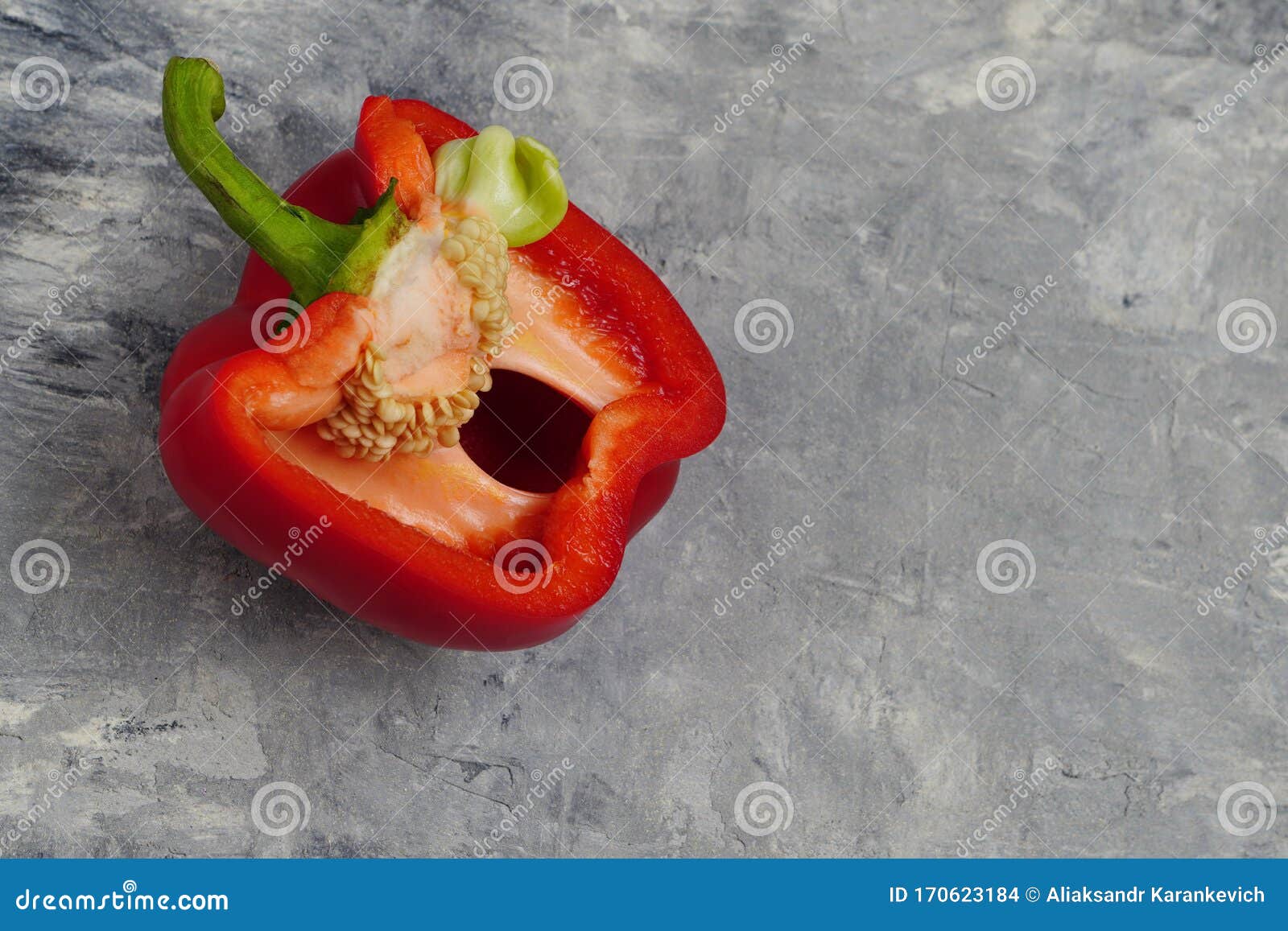 Half a Red Pepper with Seeds and a Green Tail on a Gray Concrete Stock ...