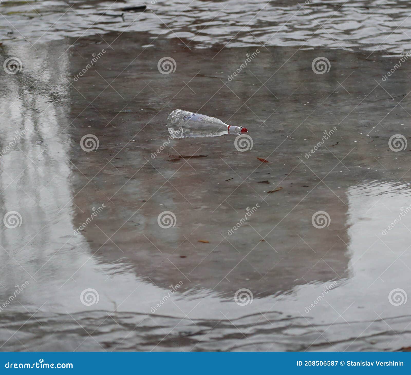 Half-submerged Glass Bottle in a Winter Puddle Stock Image - Image of ...