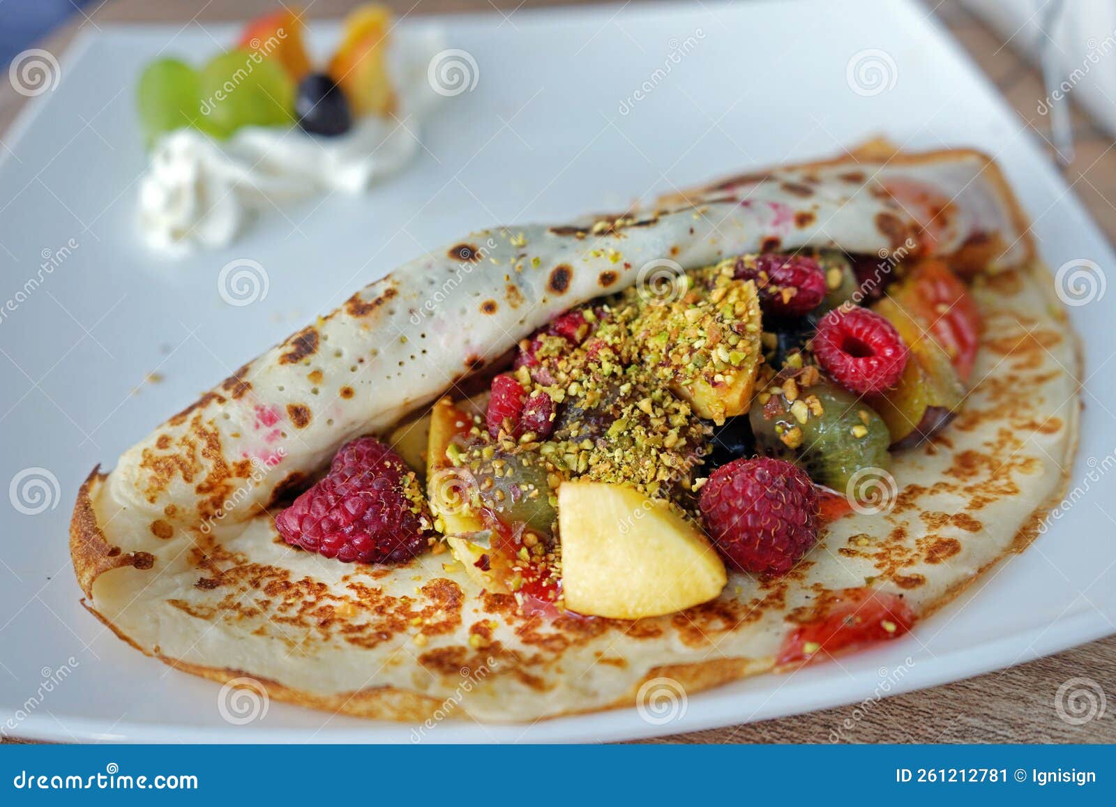 Half-wrapped Pancake with Fruit Mix, Pistachio Nuts and Raspberry Jam ...