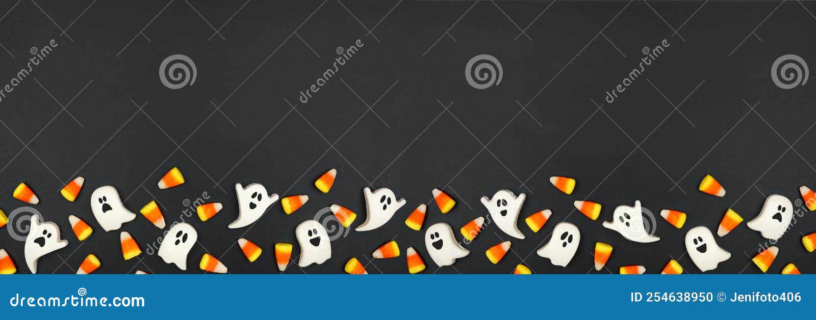 Halloween Bottom Border of Candy Corn and Spooky Chocolate Ghosts on a ...