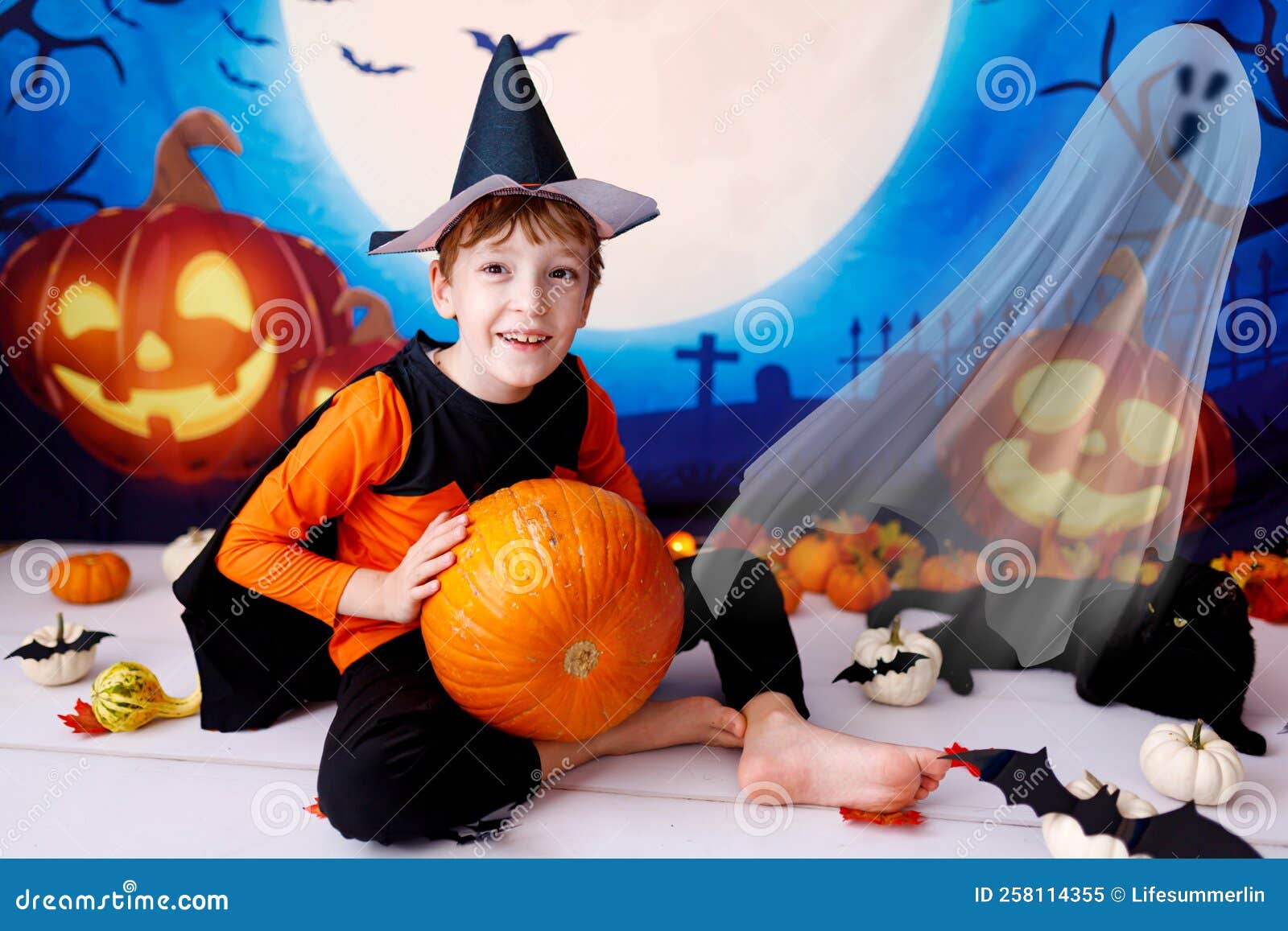Halloween Concept. Smiling Kid with Pumpkins on Halloween Spooky ...