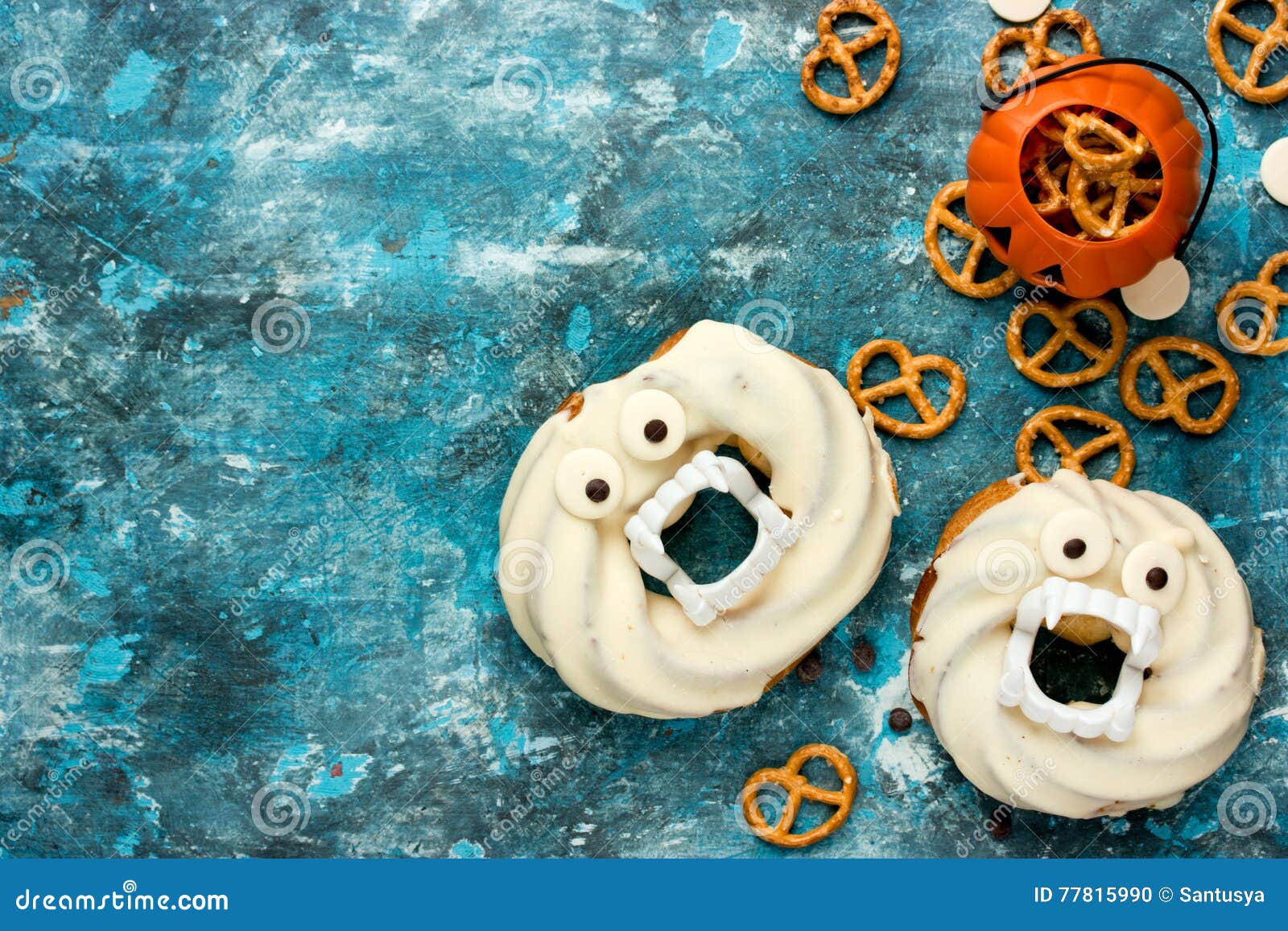 Halloween Donuts in White Chocolate with Teeth and Eyes on Blue Stock ...